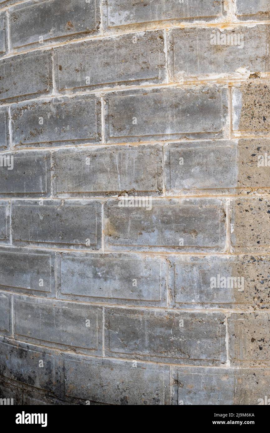 The texture of a round brickwall tower, background or backdrop, grey ...