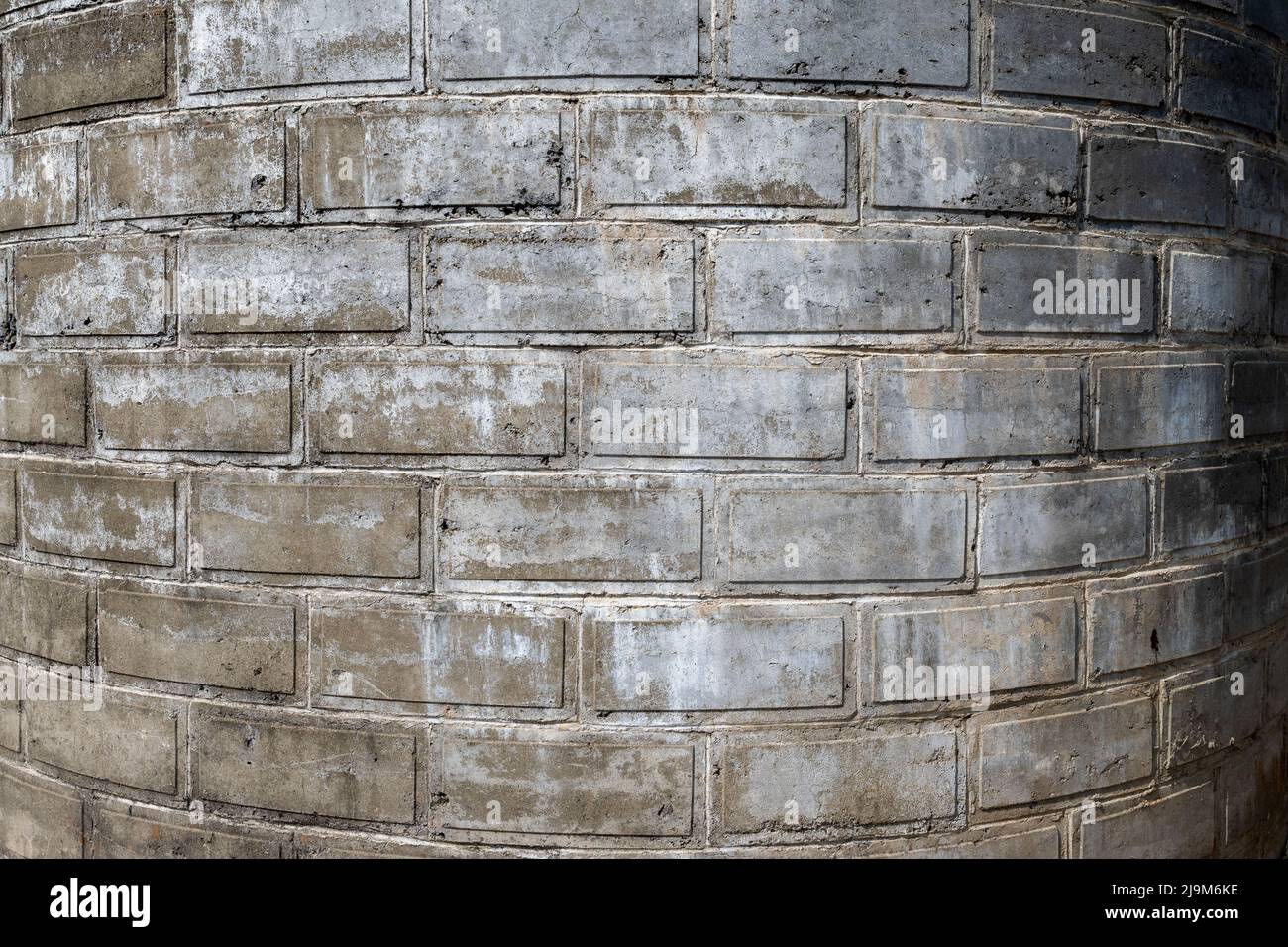 The texture of a round brickwall tower, background or backdrop, grey ...
