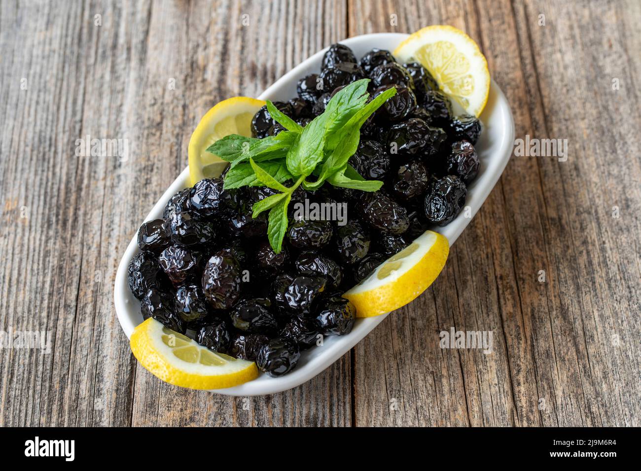 Black olive. Natural black olive on wood floor background. Healthy food ...