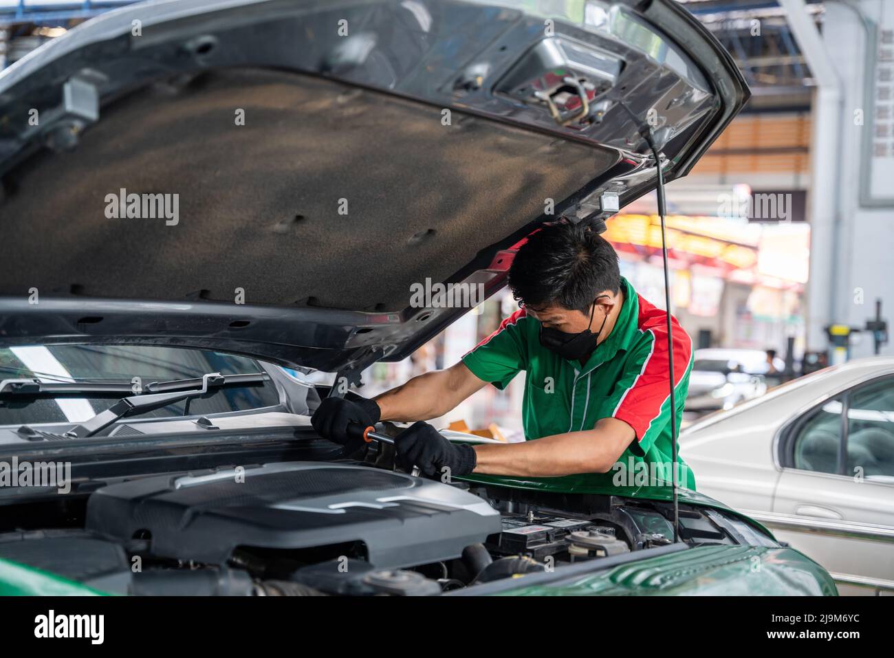 Auto Mechanic fixing repairing car engine automobile vehicle parts ...