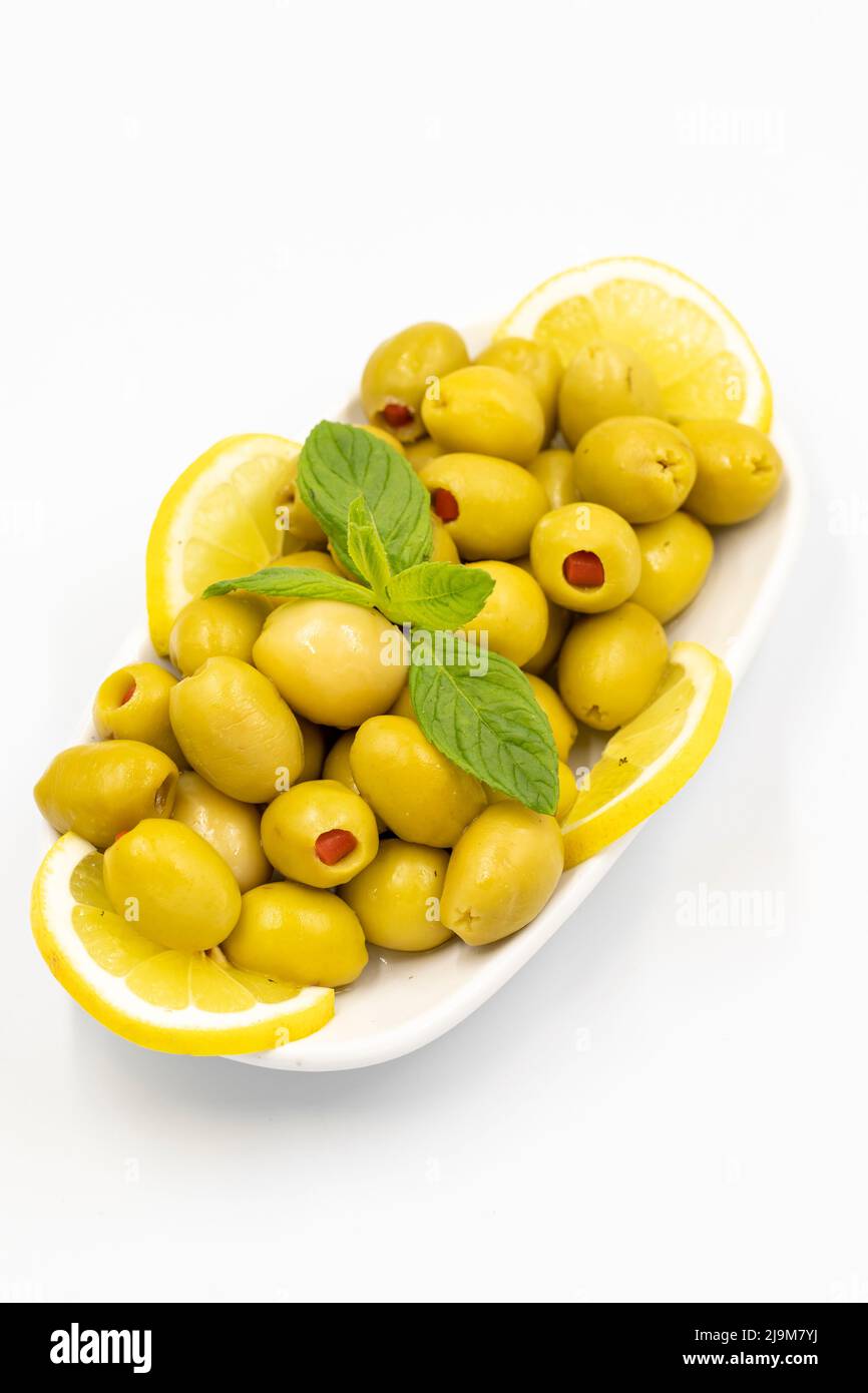 Green olives stuffed with peppers. Natural peppered olives on isolated ...