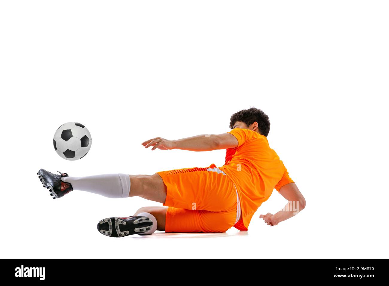 Professional football, soccer player in motion isolated on white studio ...