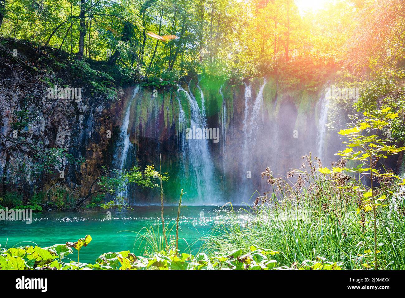 Waterfalls reflected in the lake. The magnificent landscape of the ...