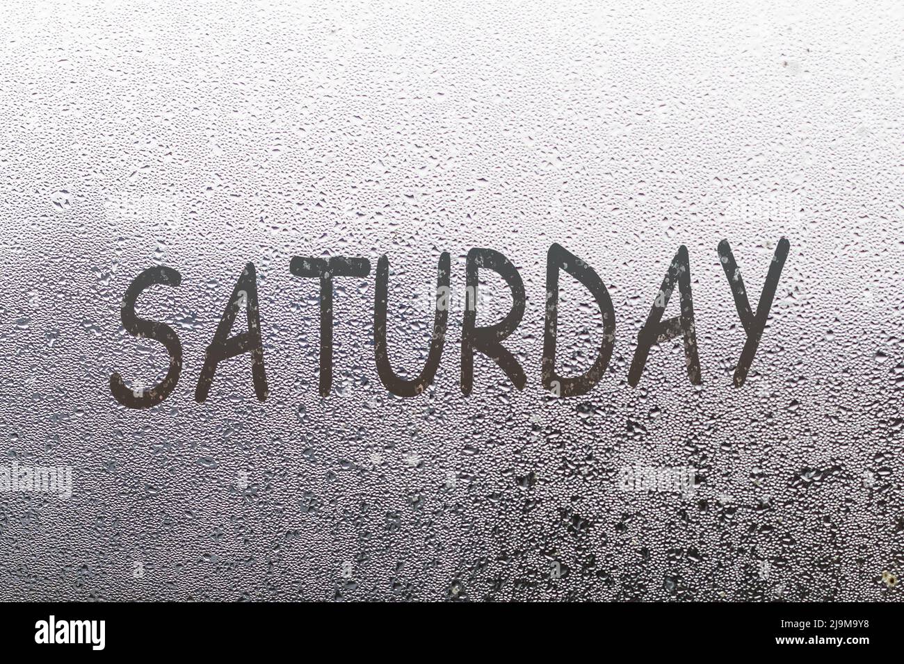 saturday written on the glass screen with raindrops background Stock ...
