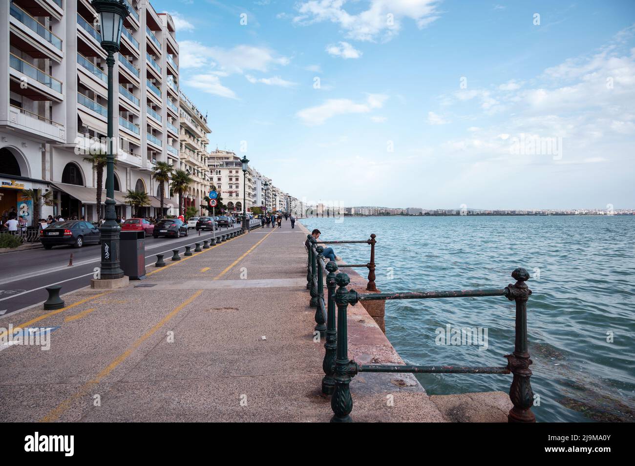 Beautiful view of the beach walk filled with busy tourists on a cloudy ...