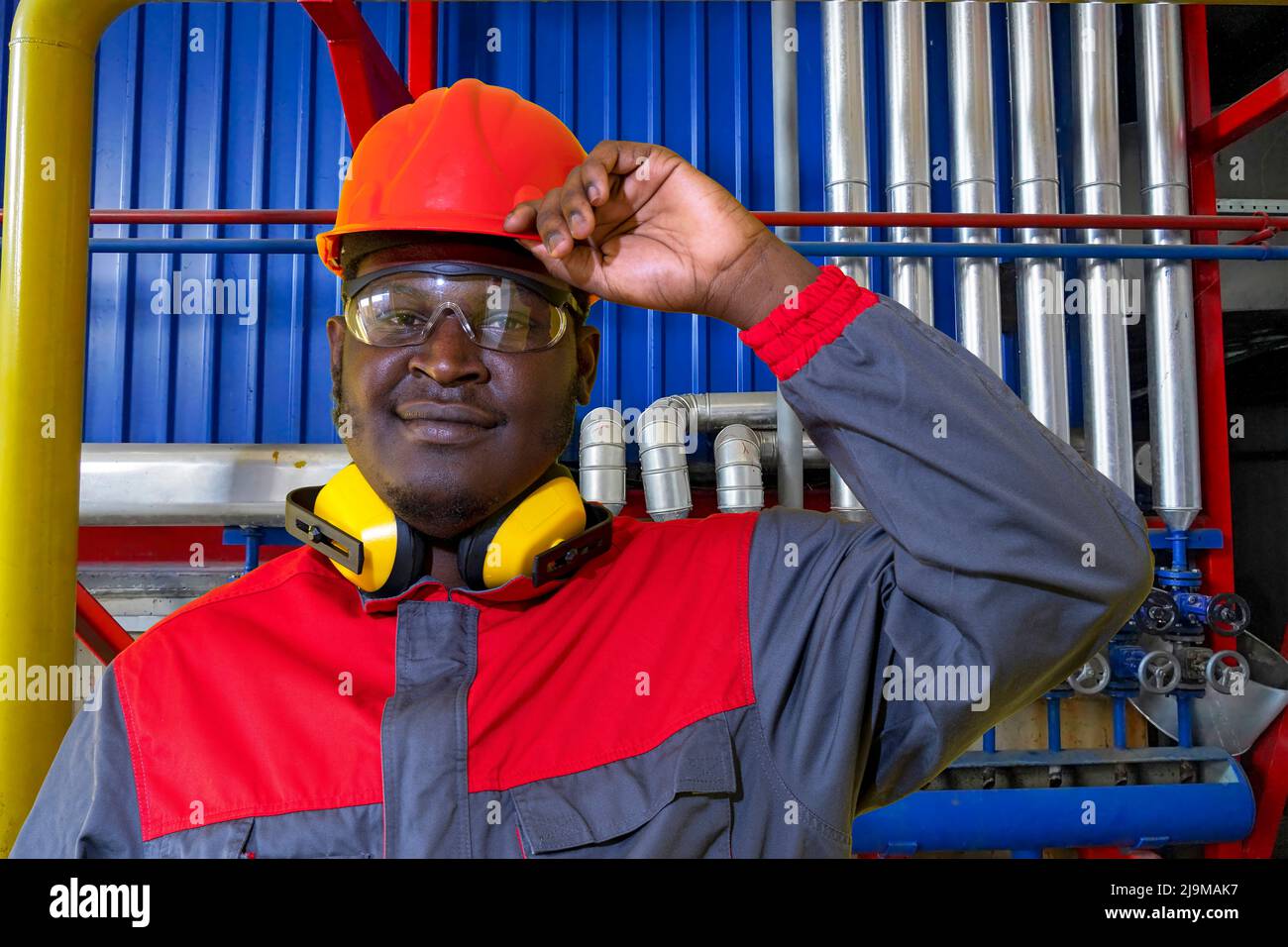 Black Industrial Worker In Red Helmet, Protective Eyewear, Hearing ...