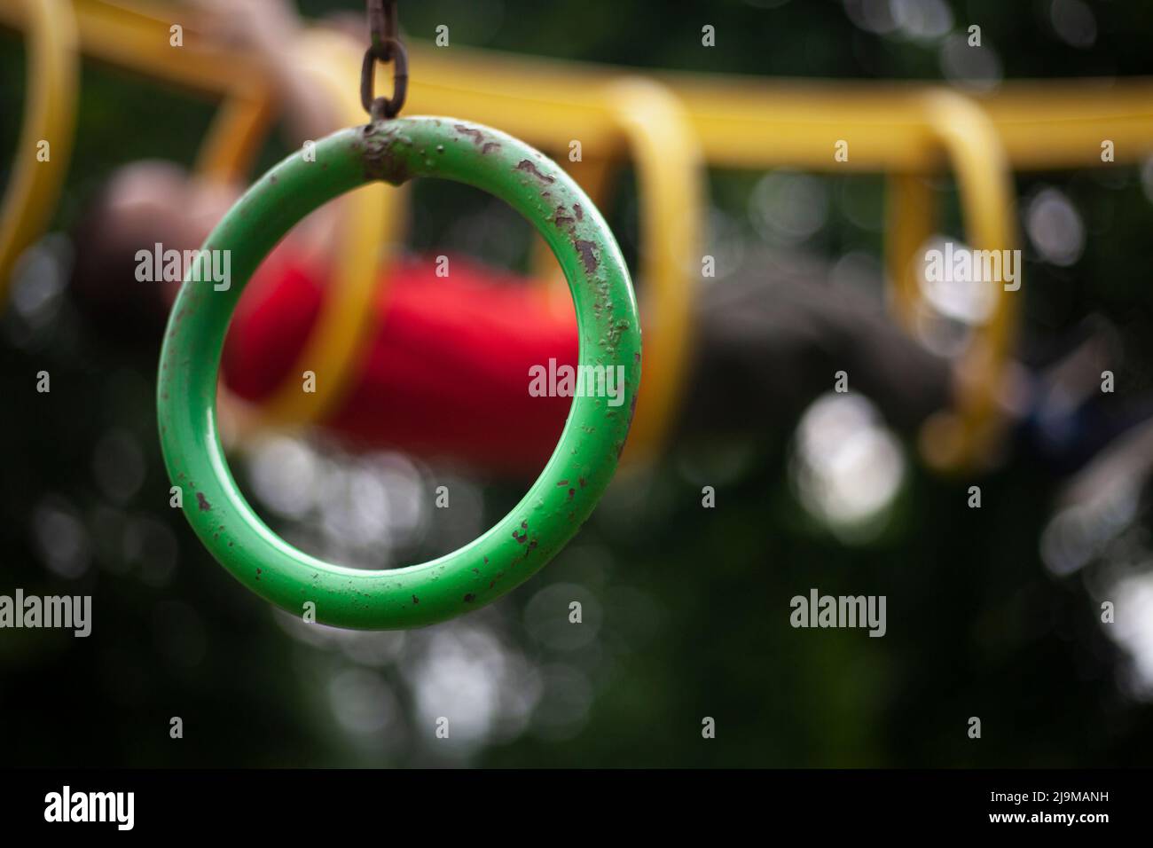 Ring in the playground for athletic exercise. A metal circle hangs on a ...