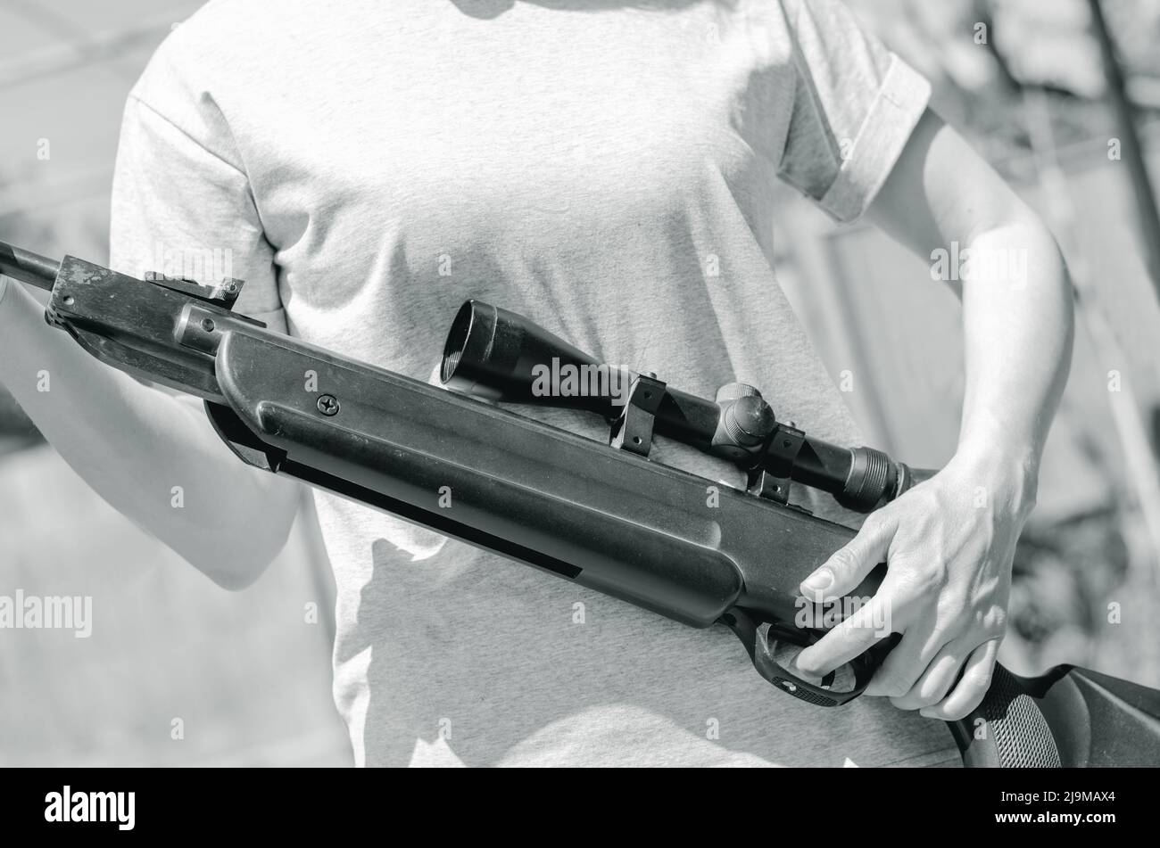 Sniper rifle in female hands. Woman holding a rifle with an optical ...