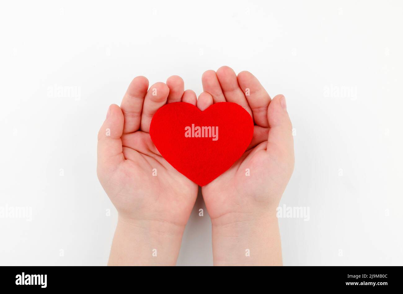 Red heart in children's hands. Child holding a red heart Stock Photo ...