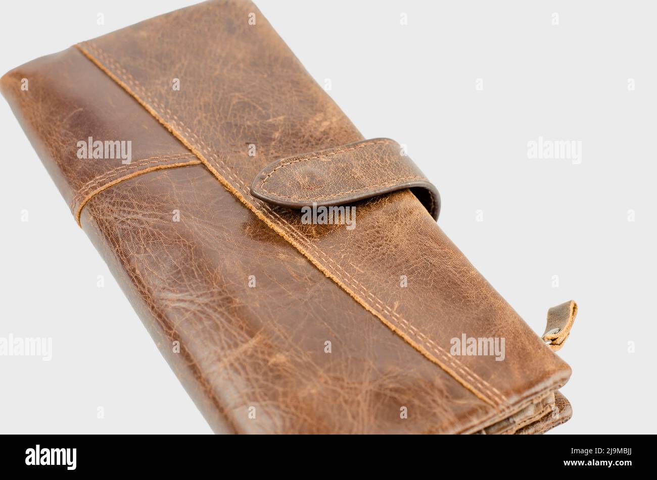 Brown men's wallet on a gray background close-up, selective focus Stock ...