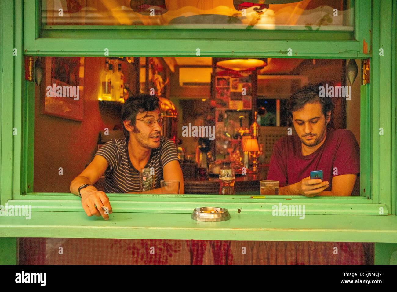 Mates hangin' out in a bar in Kolonaki, Athens Stock Photo - Alamy