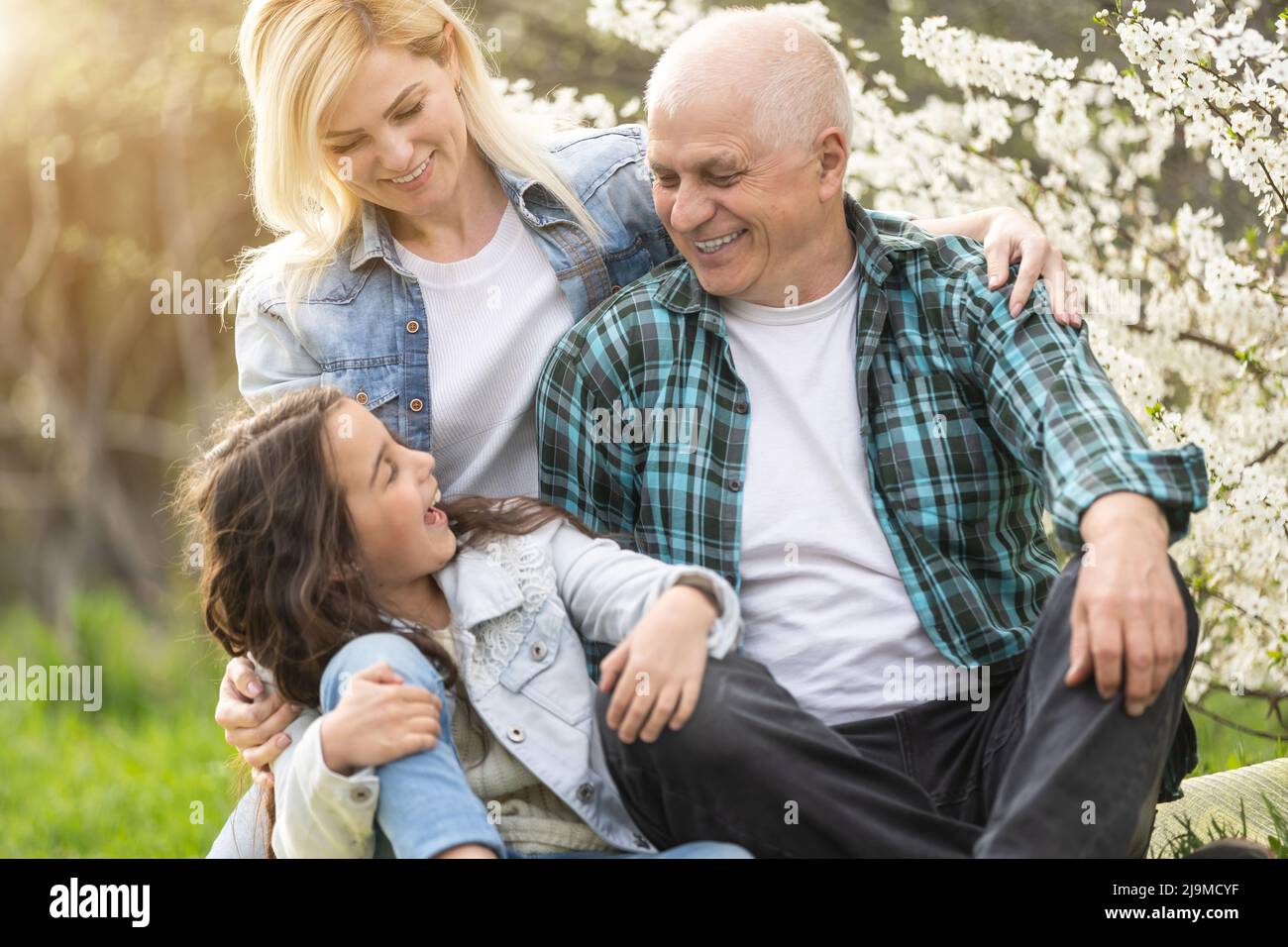 Generation Family On Grass Together in the garden Stock Photo - Alamy