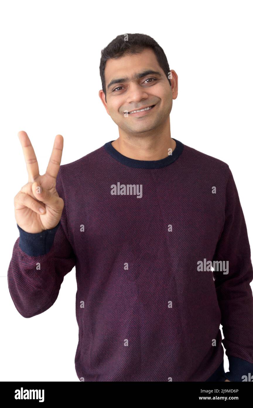 Portrait of an Indian male model showing positive signs thumbs up and ...
