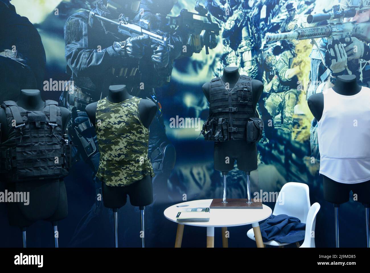 Military bandoliers, uniform and bulletproofs on stand. Arms and Safety ...