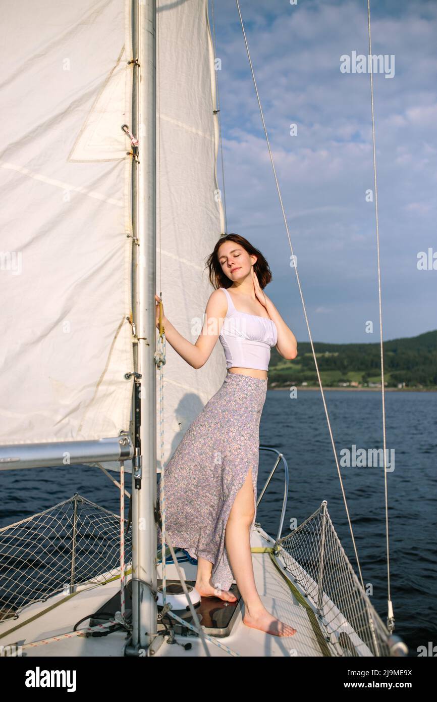 Full body of trendy young female tourist in stylish outfit standing on ...