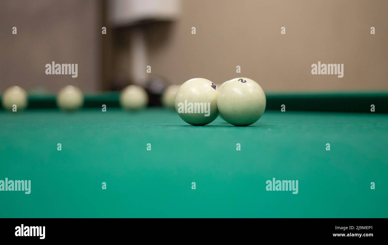 Billiard balls are white. Green billiard table. Playing in bar. Sports ...