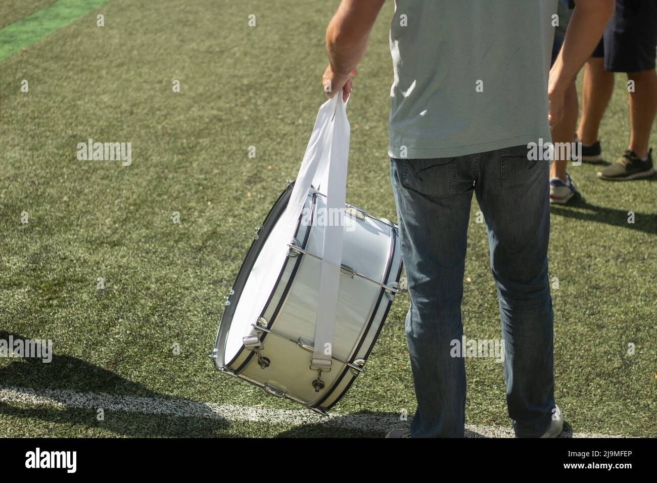 Large drum is white. Man at football game. Details of musical ...