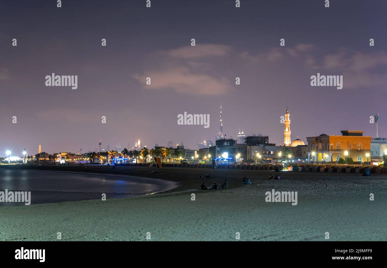 Illuminated night view of the Dubai skyline along with the beachfront ...