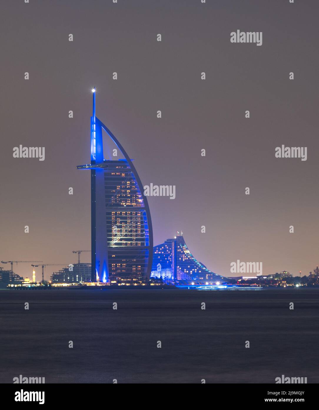 View of the illuminated Burj Al Arab, the iconic 7 star hotel in Dubai ...