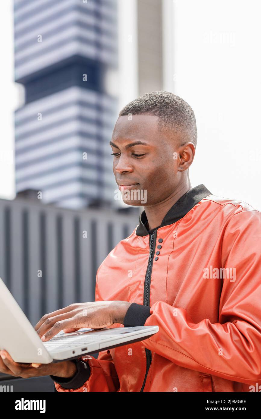 Side view of focused young African American male student in stylish ...