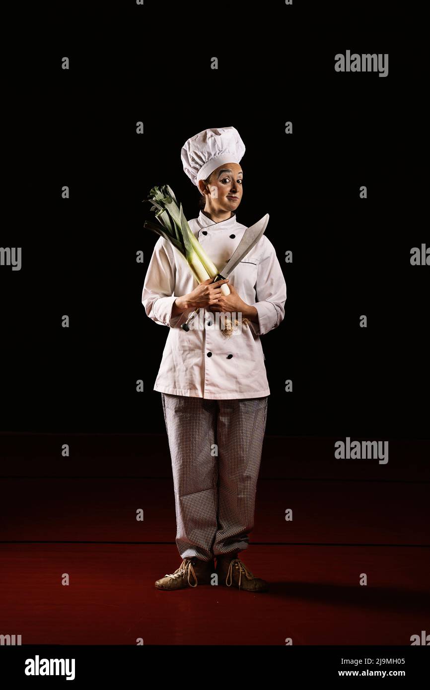 Full body of positive young female clown in chef outfit with makeup ...