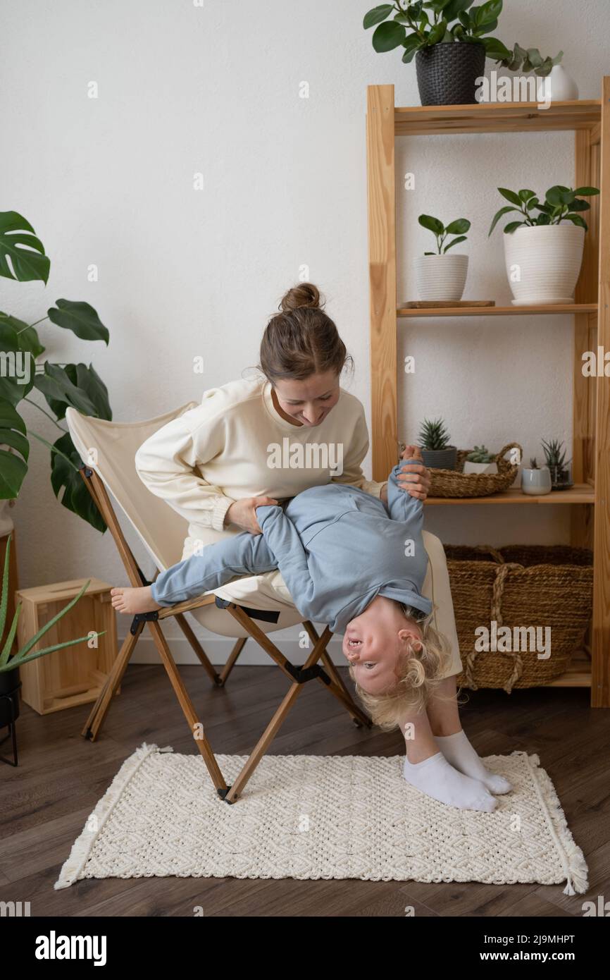 Full body of happy calm female in casual clothes sitting on chair ...