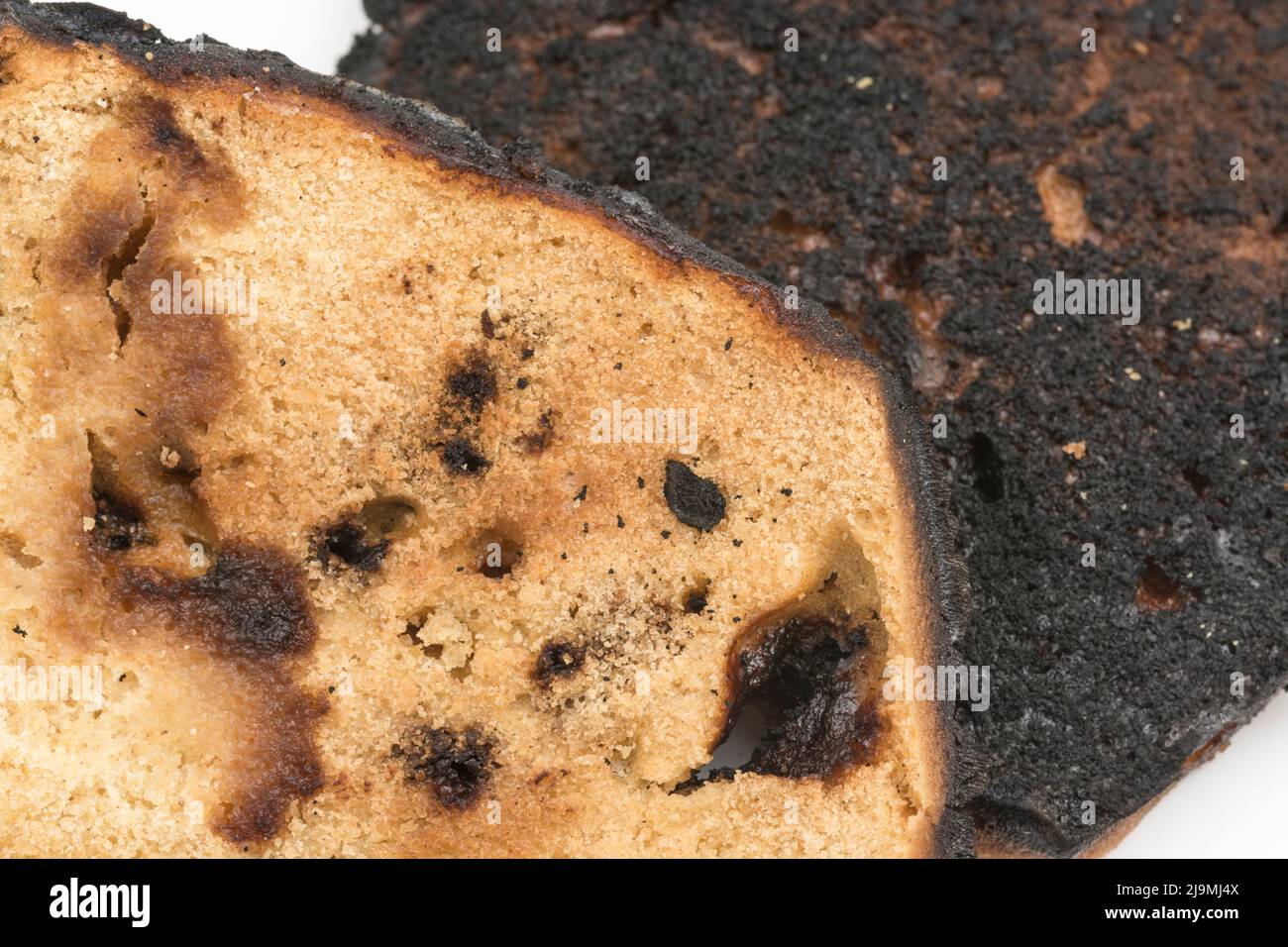 Bread which has been overcooked and burnt to a cinder on one side. For ...