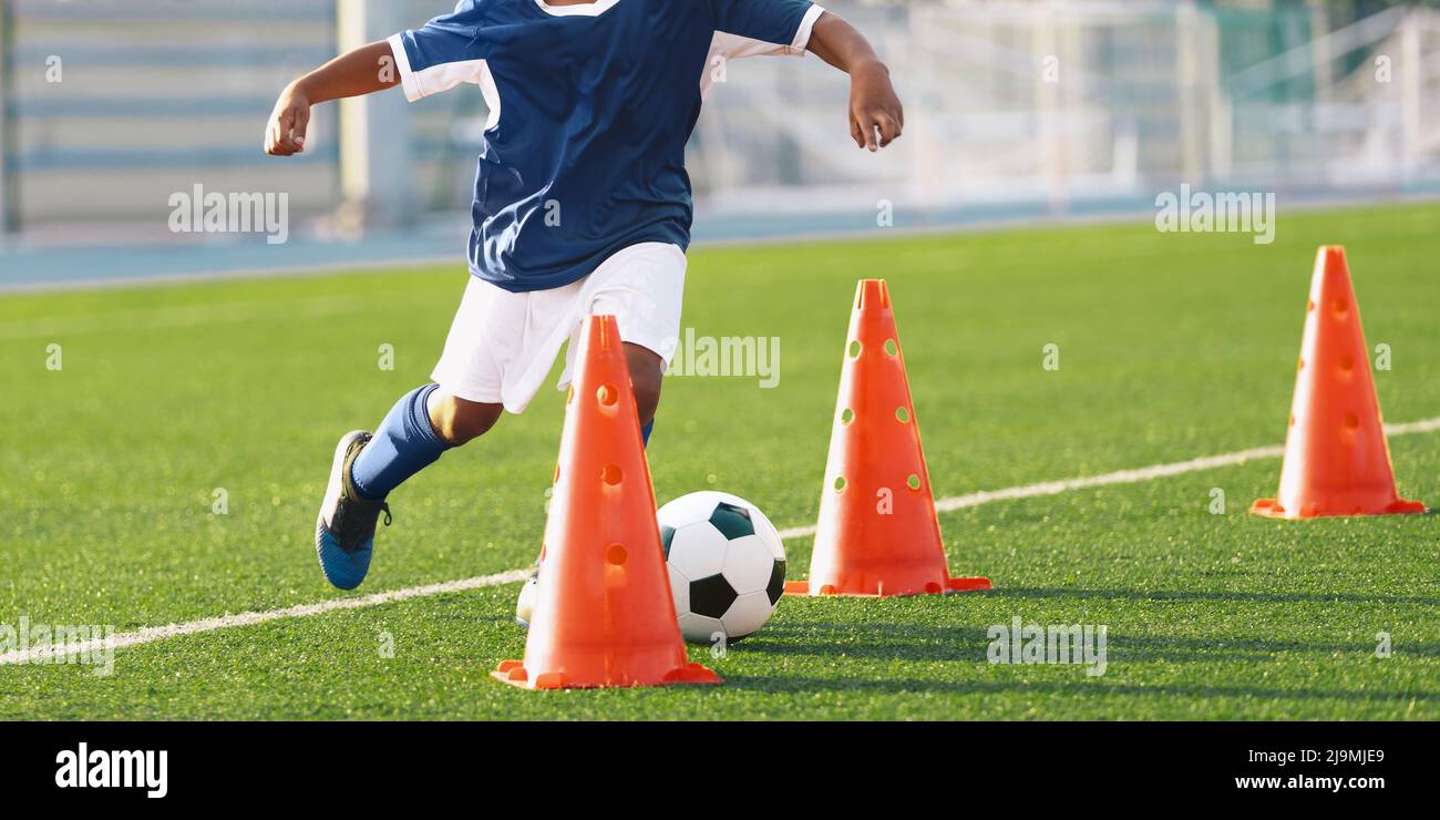 Soccer ball control exercises for kids. Child playing soccer ball on ...