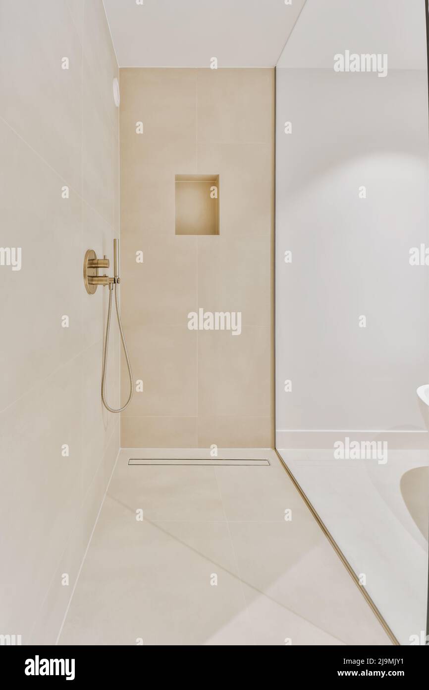 Interior of modern shower cabin with tiled walls and built in shelf and ...