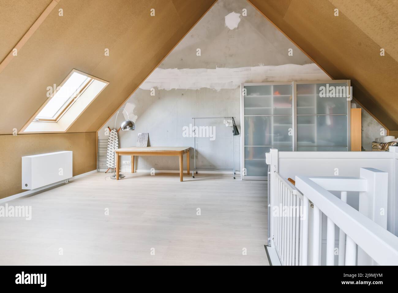 Wardrobe with translucent doors located near empty rail and table in ...