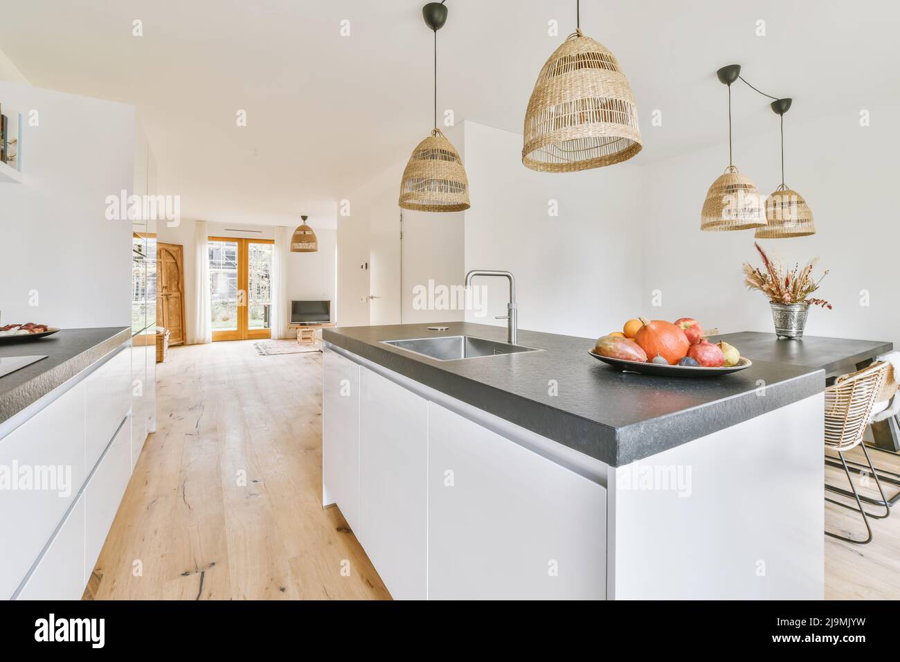 Contemporary counters with sink located in middle of light kitchen with ...