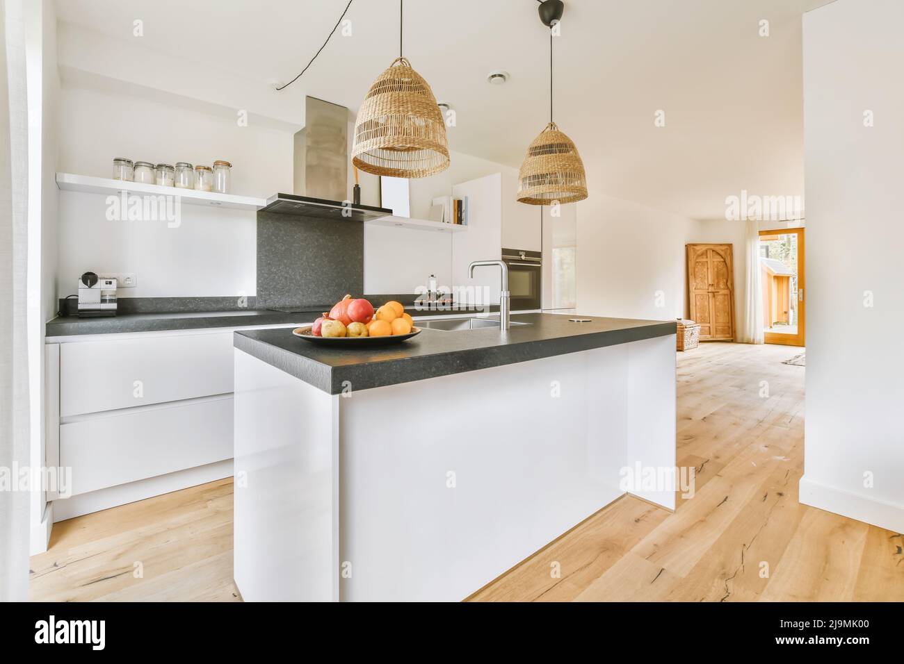Contemporary counters with sink located in middle of light kitchen with ...
