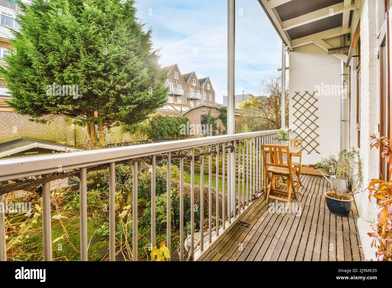 Chairs and table neat metal fence on terrace of residential building ...