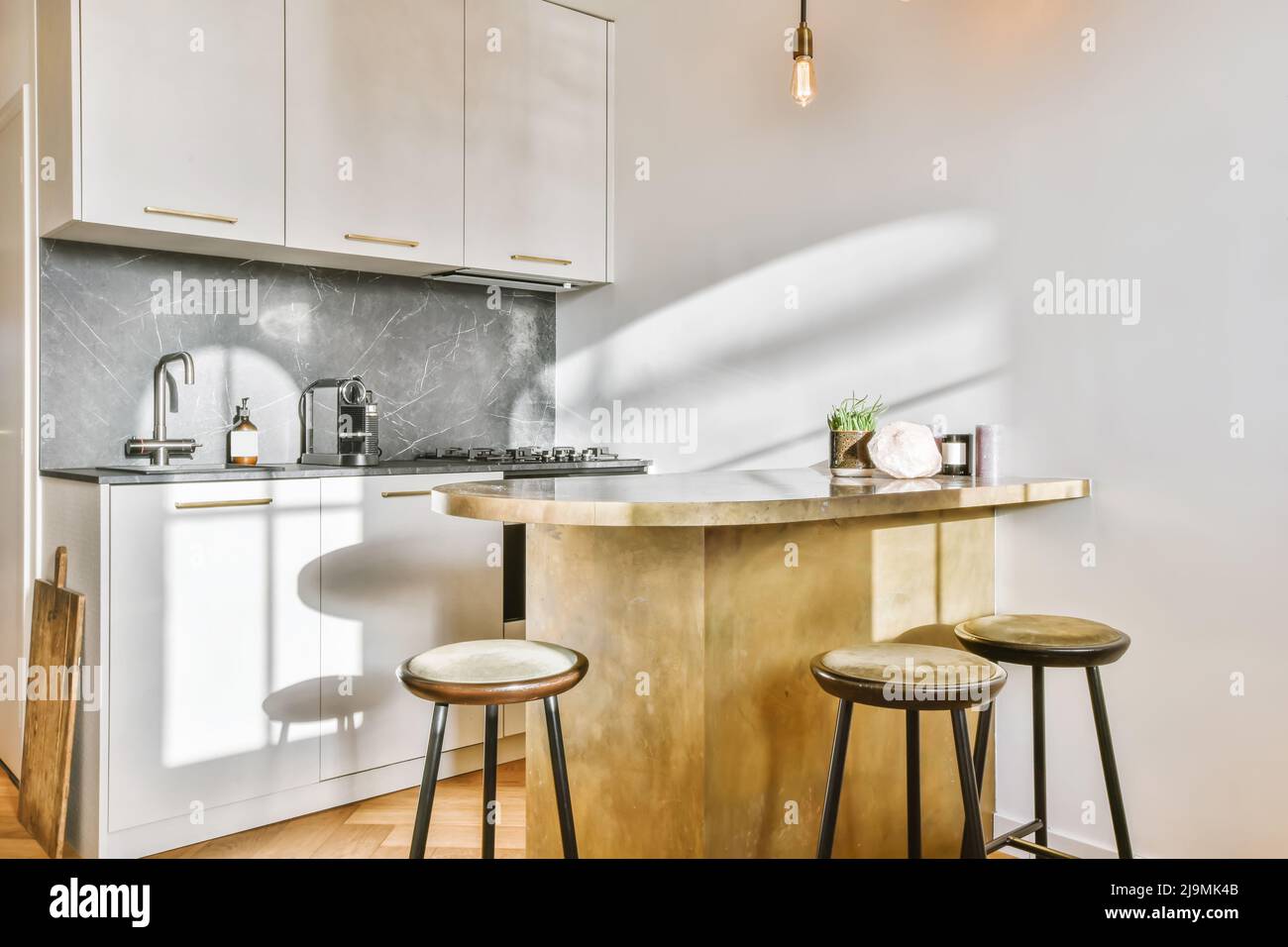 Contemporary counters with kitchen island located in middle of light ...