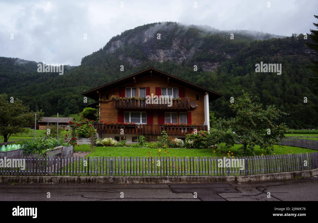 View of a beautiful alpine wooden chalet house with a beautiful and ...