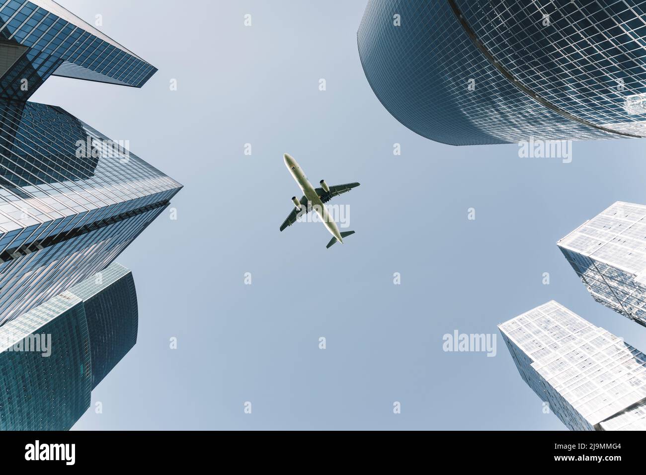 Business city center buildings with flight plane background. Modern ...