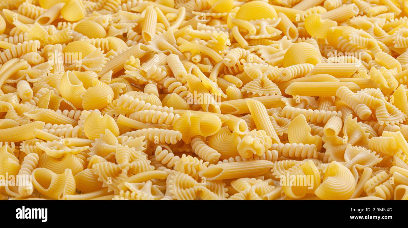 Different types and shapes of Italian pasta background Stock Photo - Alamy