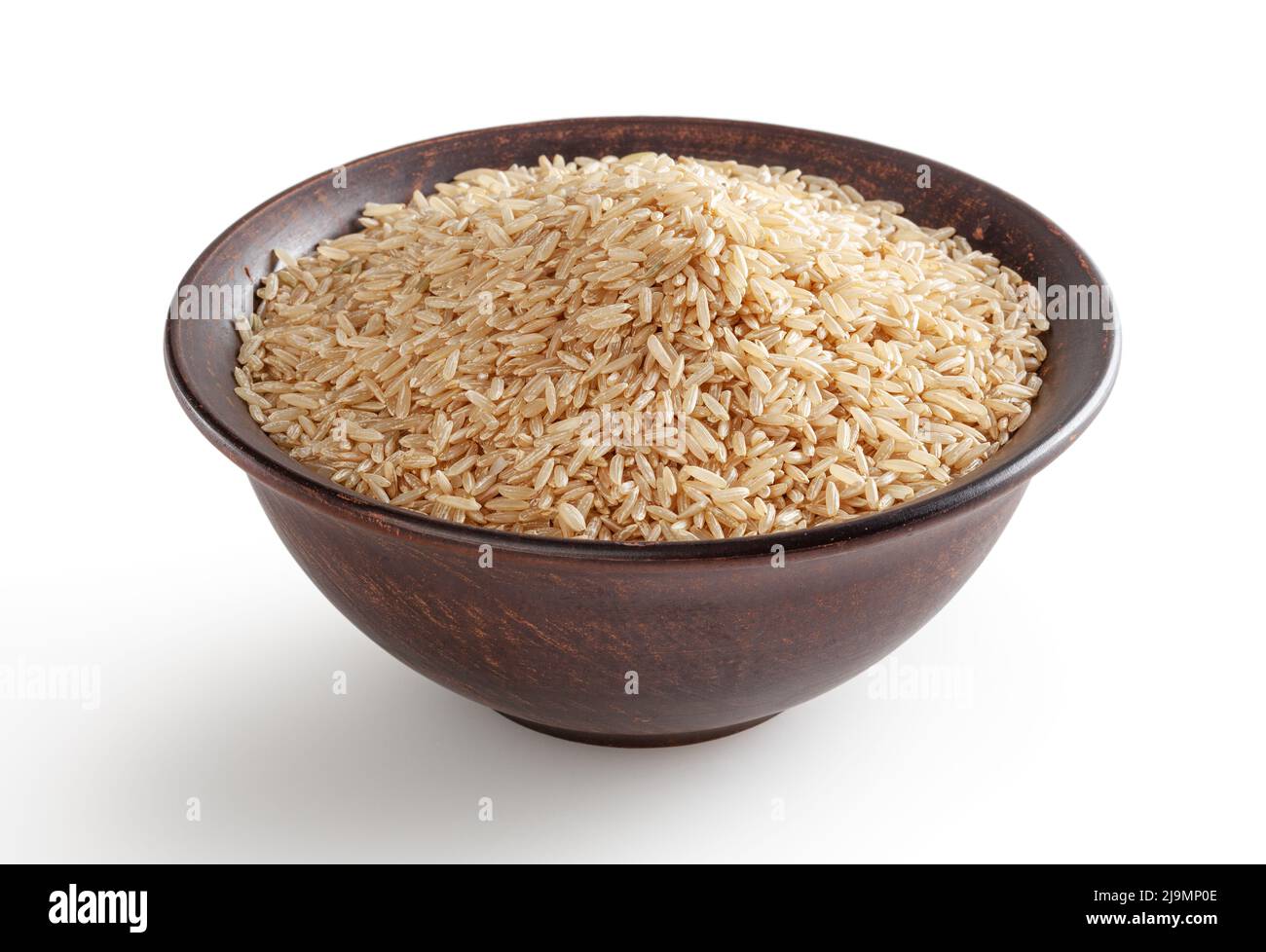 Brown rice in ceramic bowl isolated on white background with clipping ...