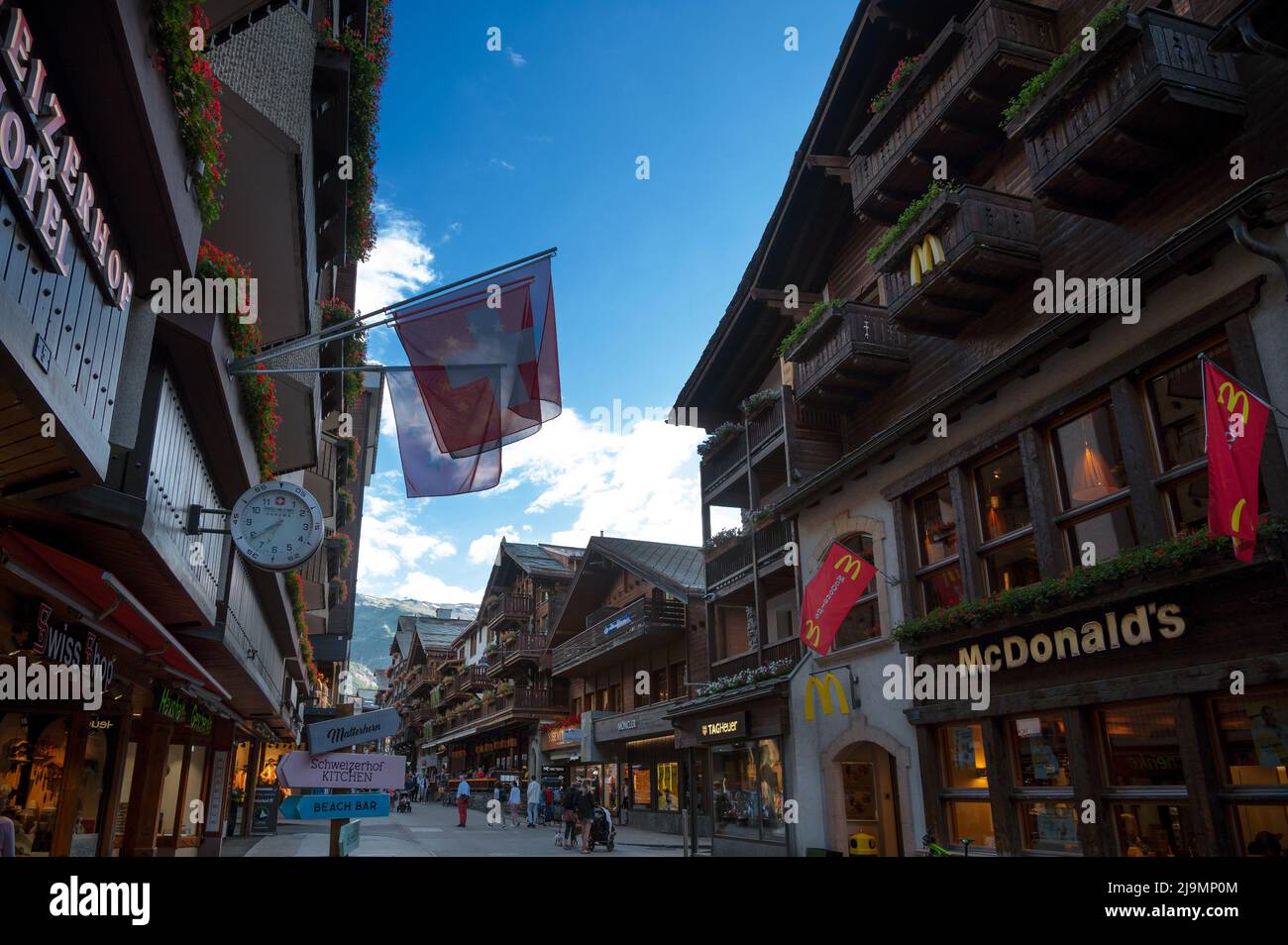 View of souvenir shops at the main shopping street of Zermatt a car ...