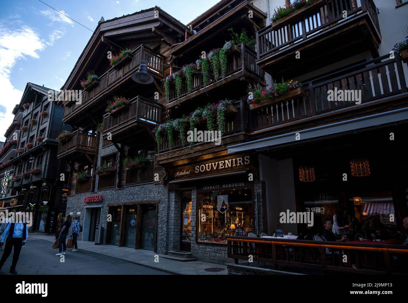 View of souvenir shops at the main shopping street of Zermatt a car ...