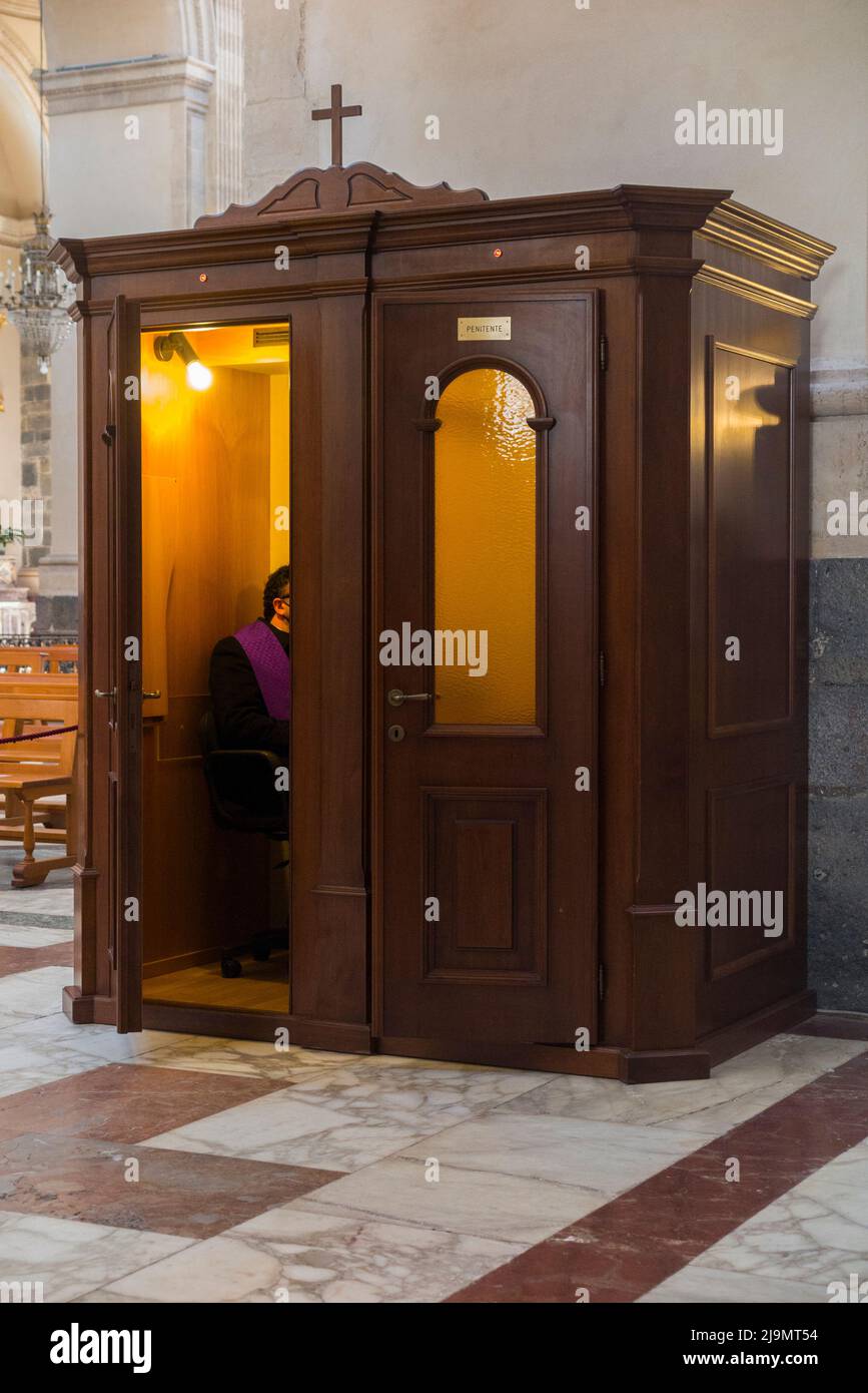 Confessional box with a priest waiting for someone who wishes to ...