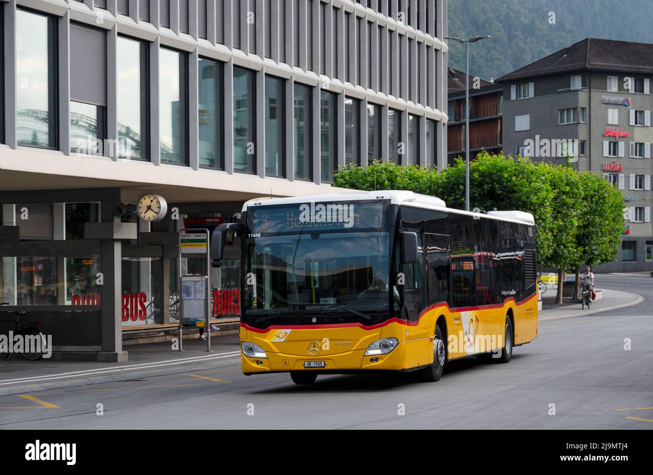 View of a public transport bus at the bus stop along with commuters ...