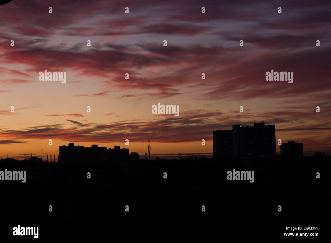 Beautiful violet sunset over the night city. Sunset and purple clouds ...