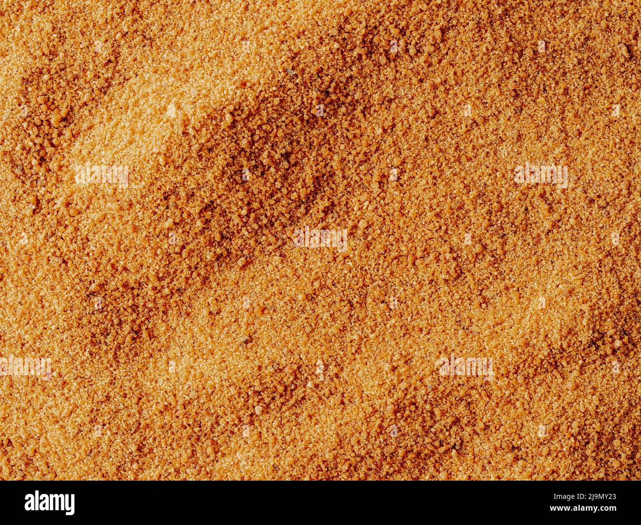 Background texture of raw organic coconut sugar from crystallized sap ...