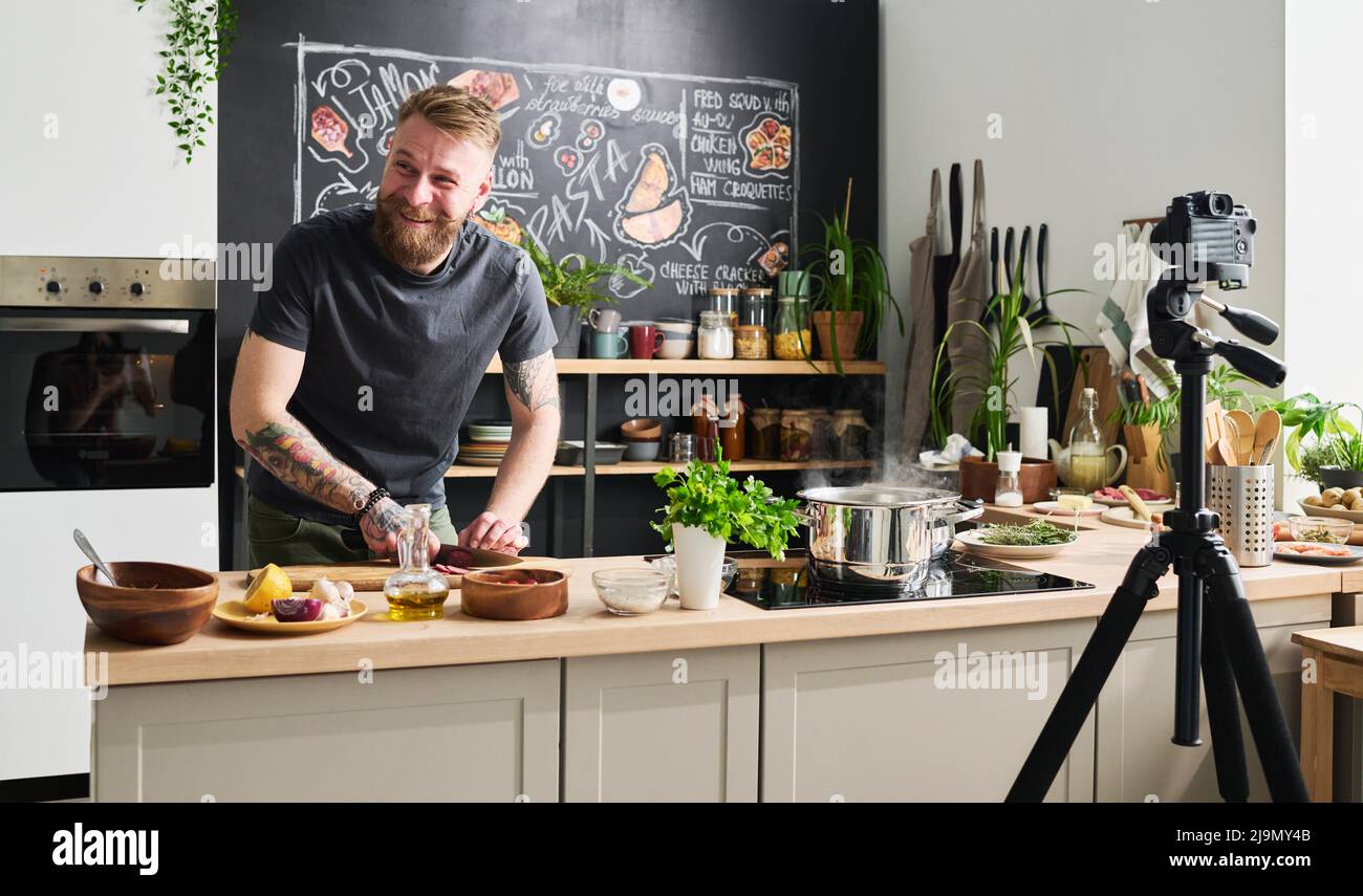 Joyful young adult Caucasian man with beard on face smiling at ...