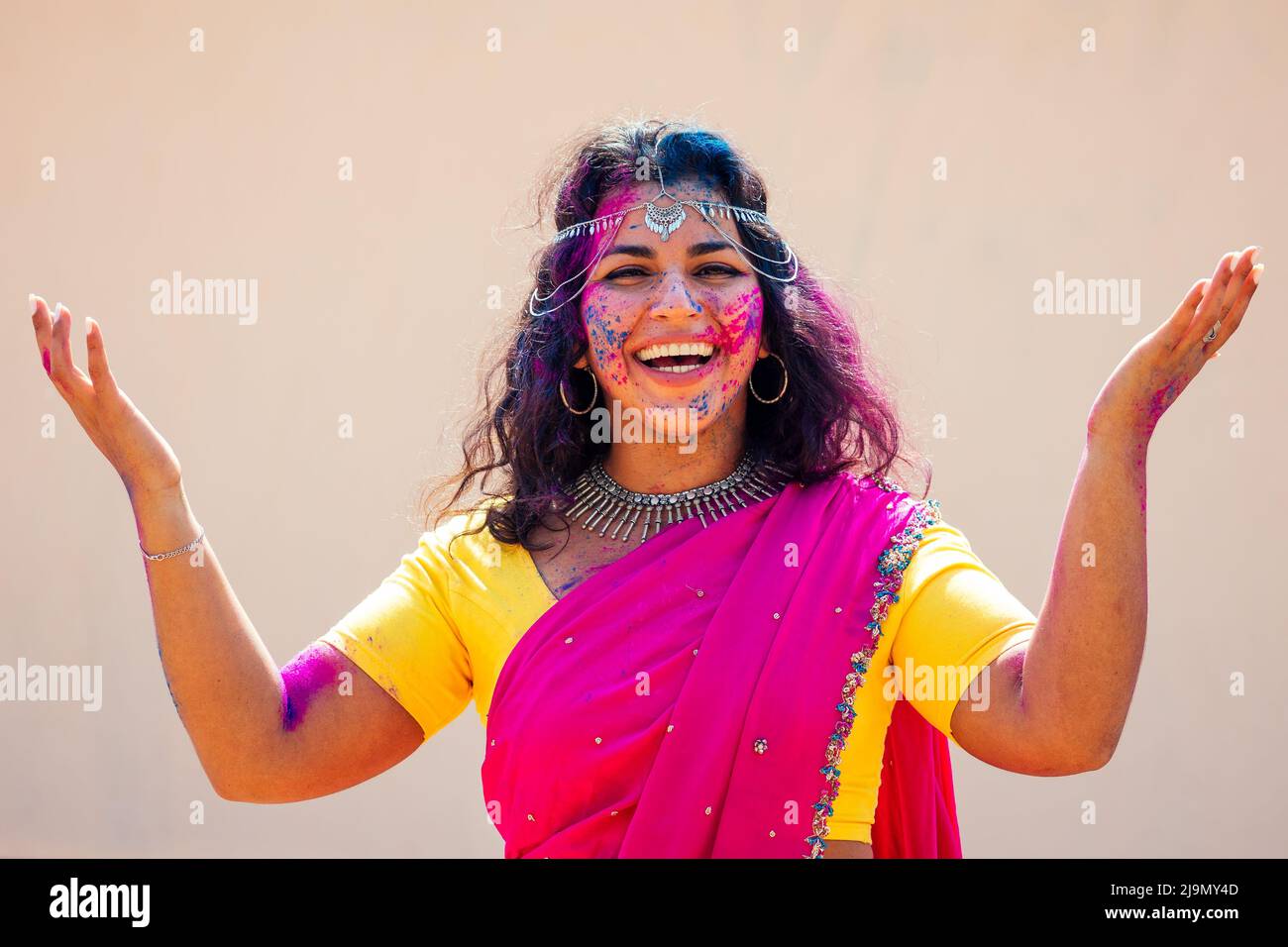 Portrait of young Indian face in paint Woman in traditional indian pink ...