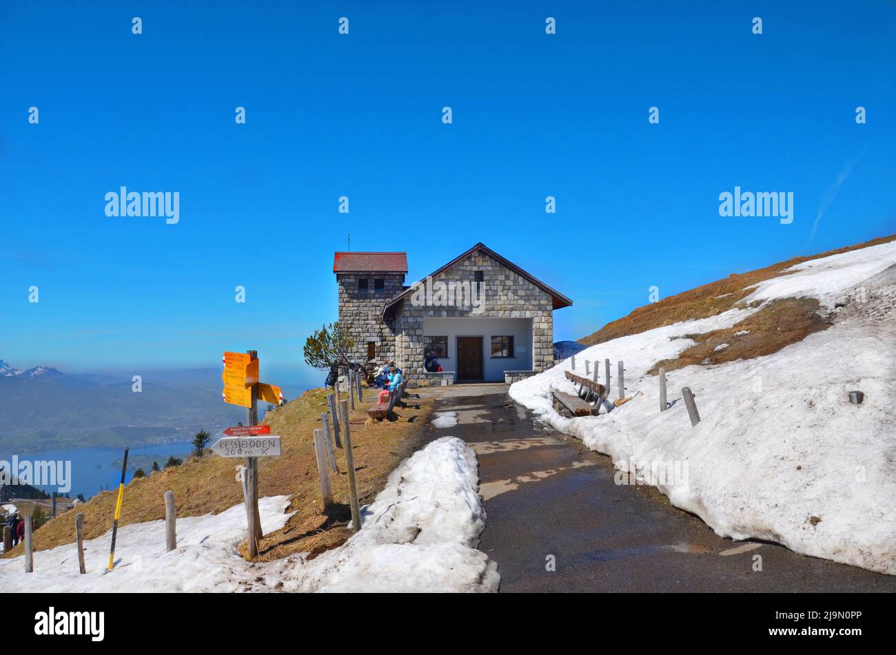 A wooden cottage hut at the top of rigi mountains surrounded by white ...