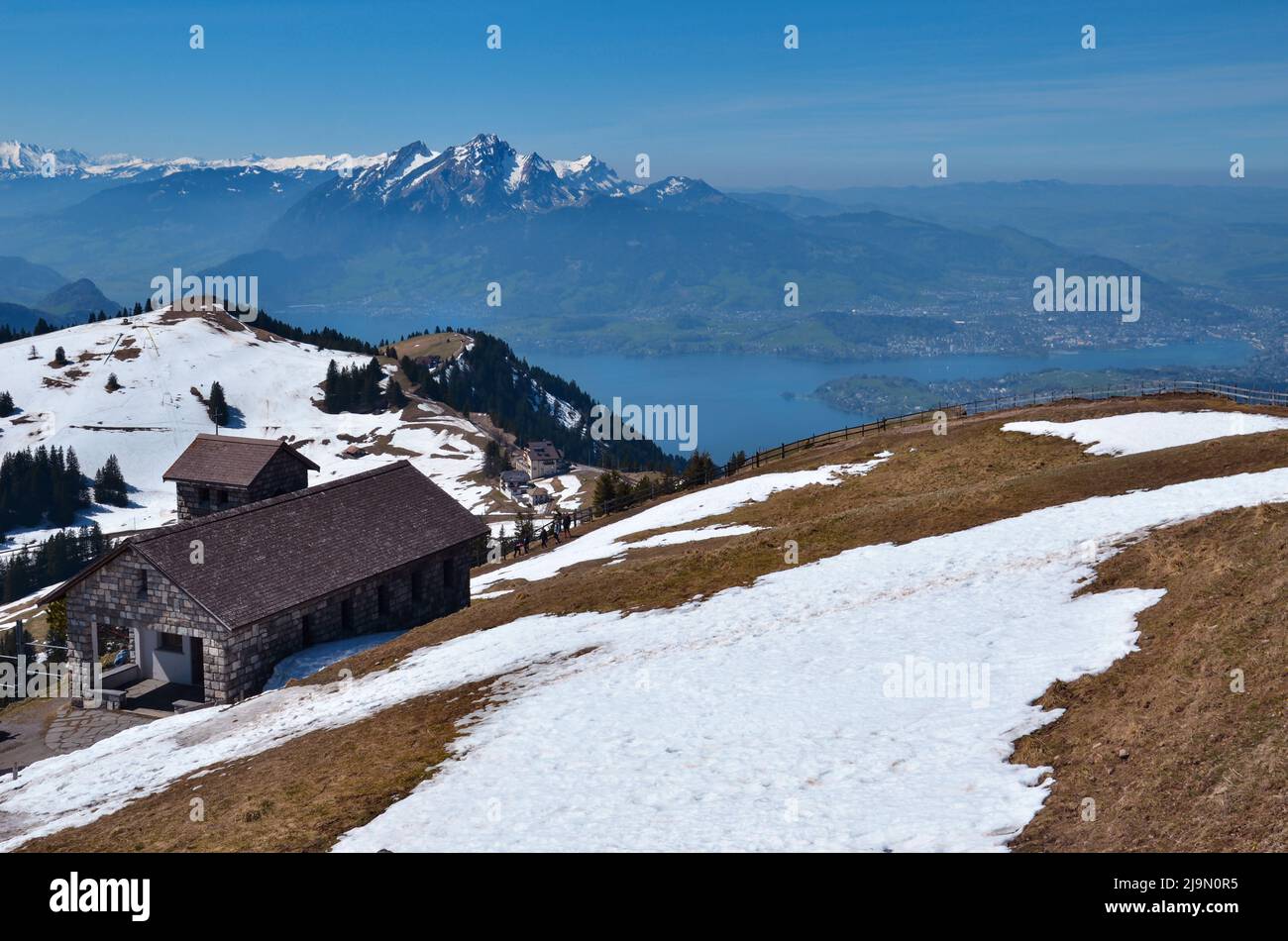 A wooden cottage hut at the top of rigi mountains surrounded by white ...