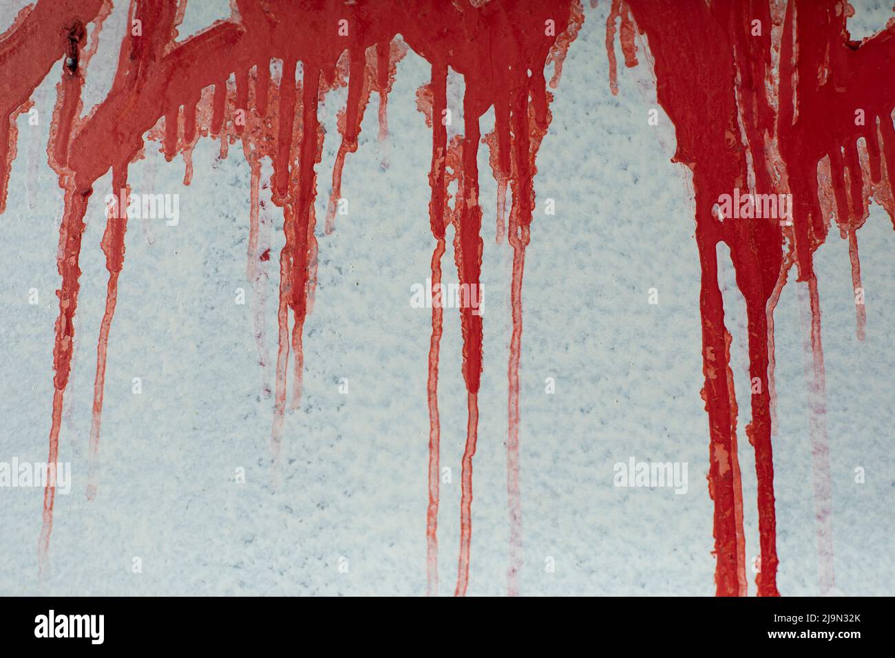 Red paint flows down wall. Graffiti details. Smudges from paint on ...