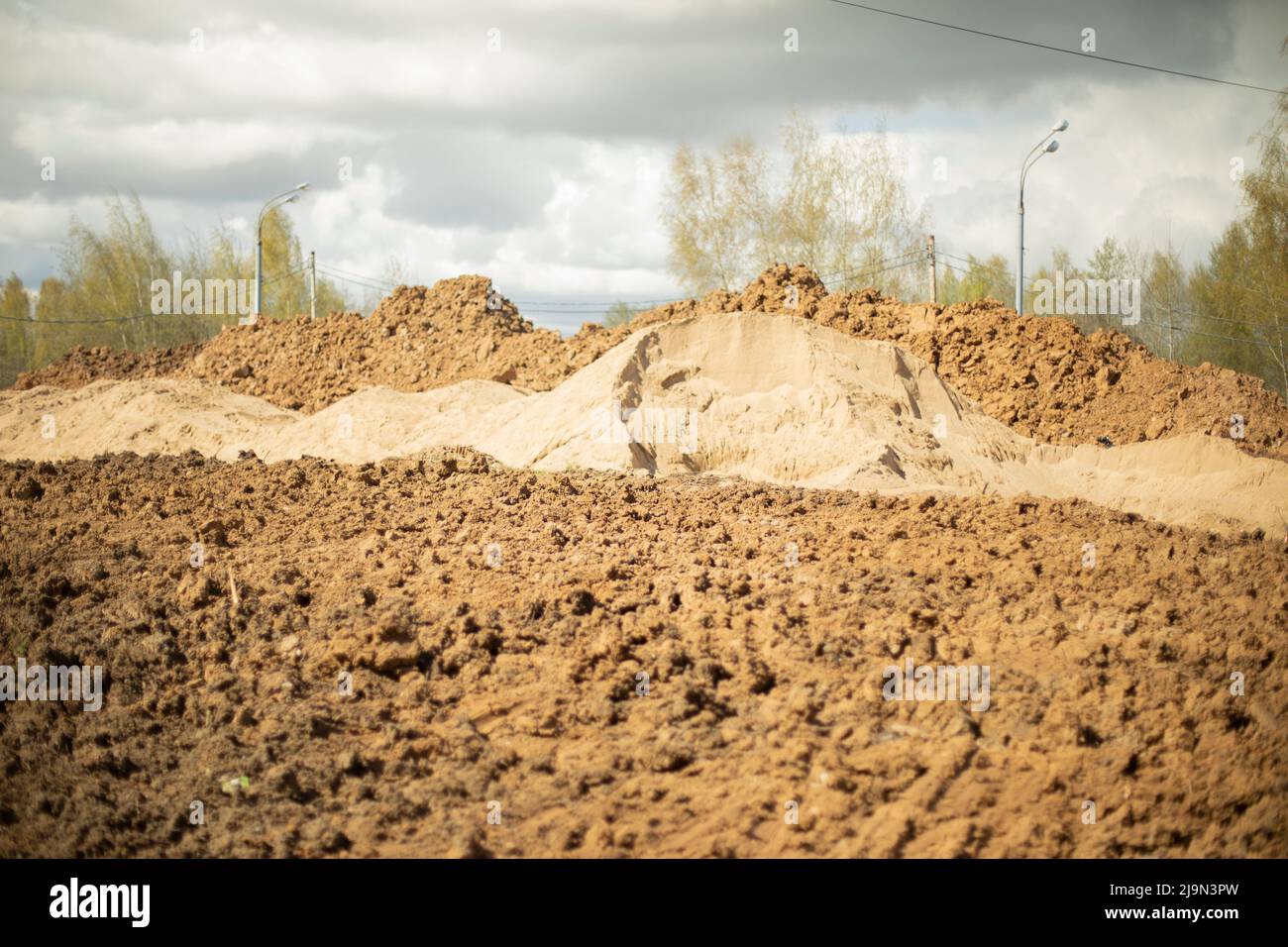 Construction sand. Mountain of sand on construction site. Excavated ...